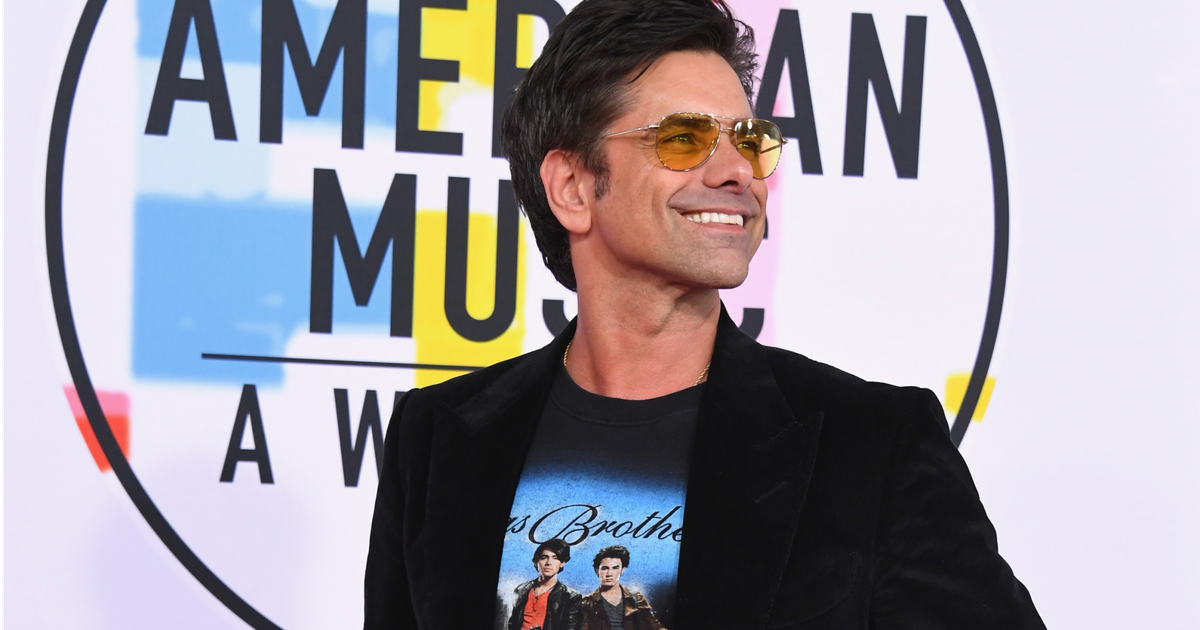Nick Jonas and John Stamos have been going back and forth wearing ...