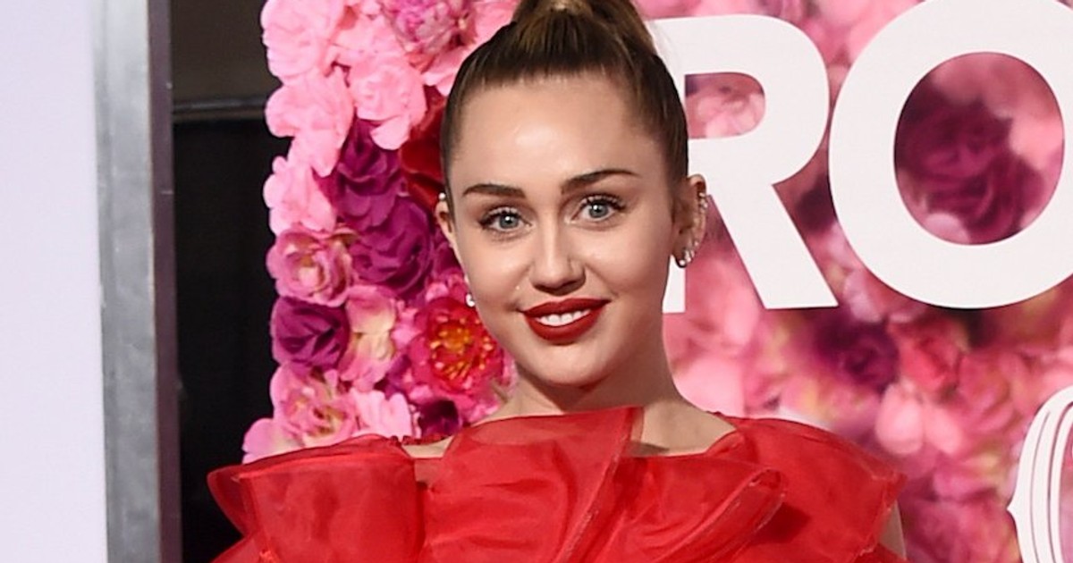Miley Cyrus put a glamorous twist on the sheer trend in a red ball gown ...