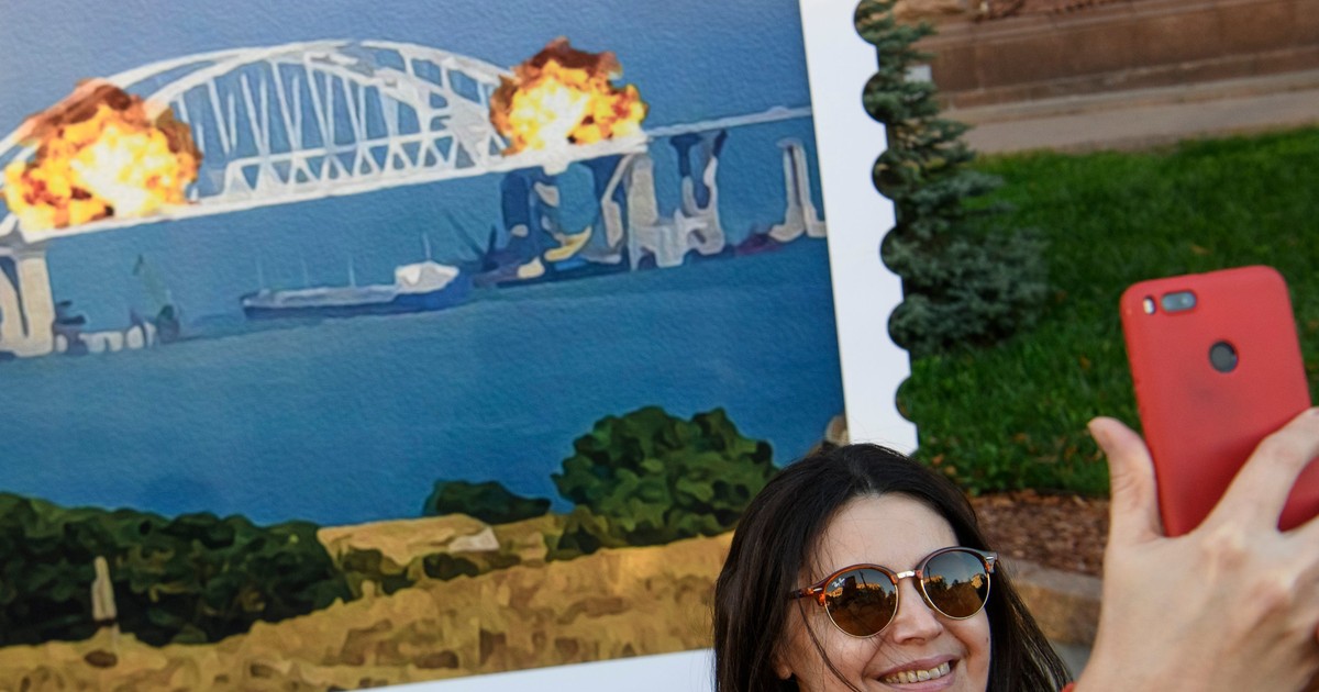 Ukrainians are posing with a giant postage stamp depicting the blown up ...