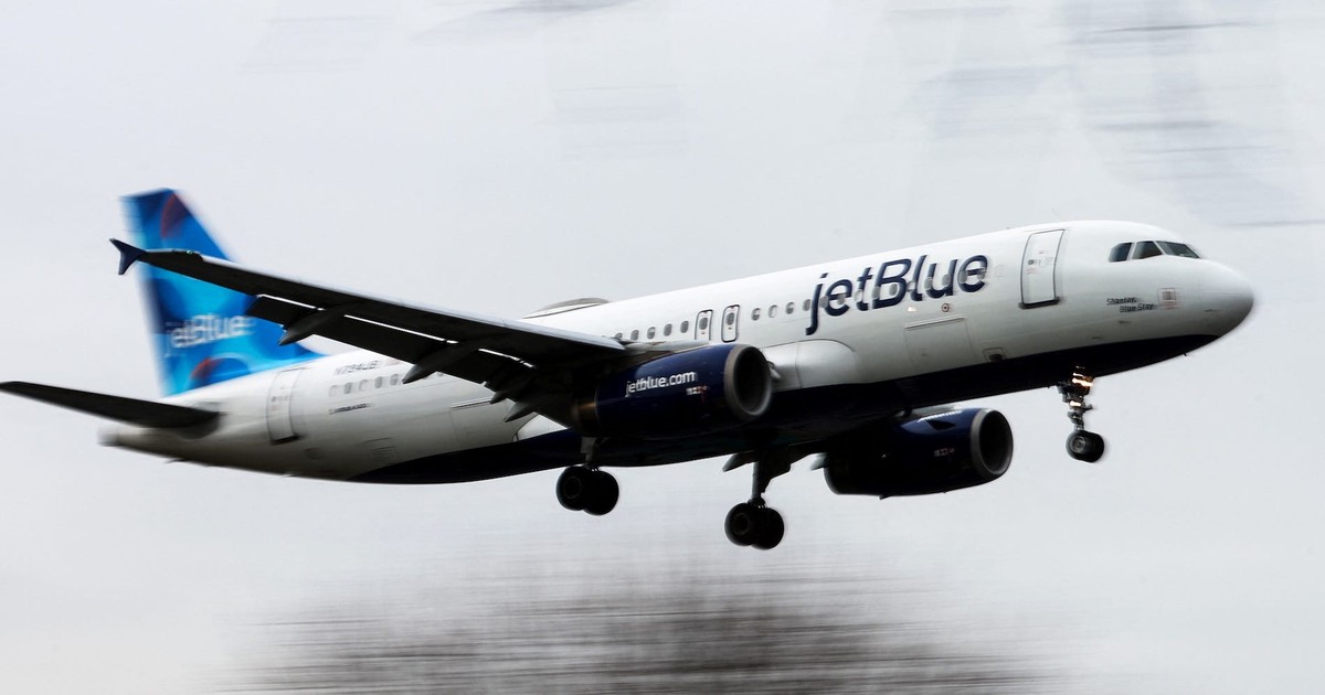 A JetBlue plane tipped backwards, its front wheel off the ground, while ...