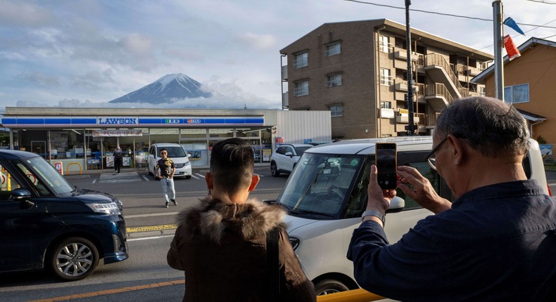 Tourists are already poking holes in the Mount Fuji barrier built by a ...